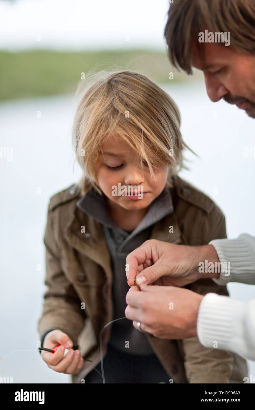 Father and son preparing fishing bite Stock Photo - Alamy