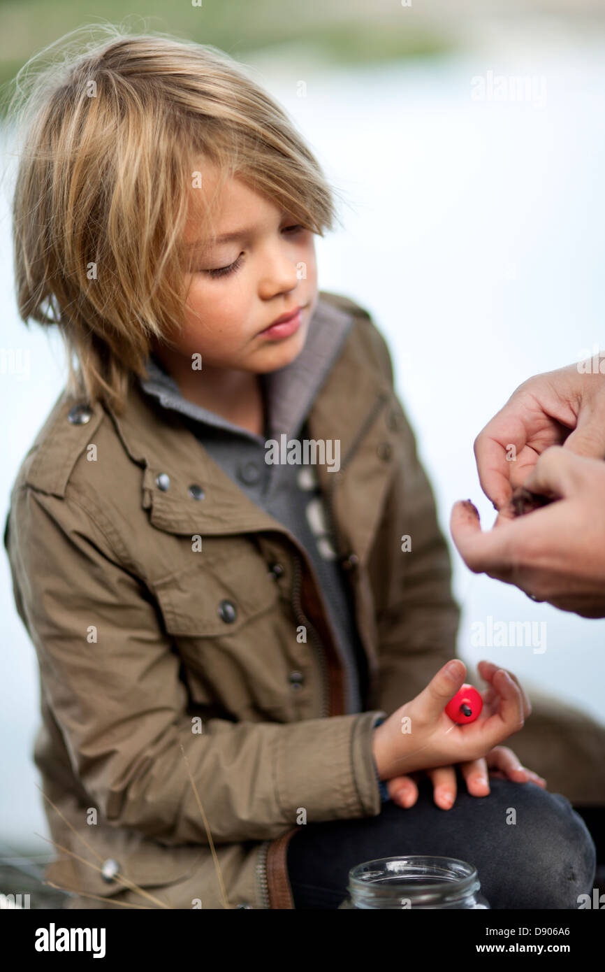 Father and son preparing fishing bite Stock Photo - Alamy