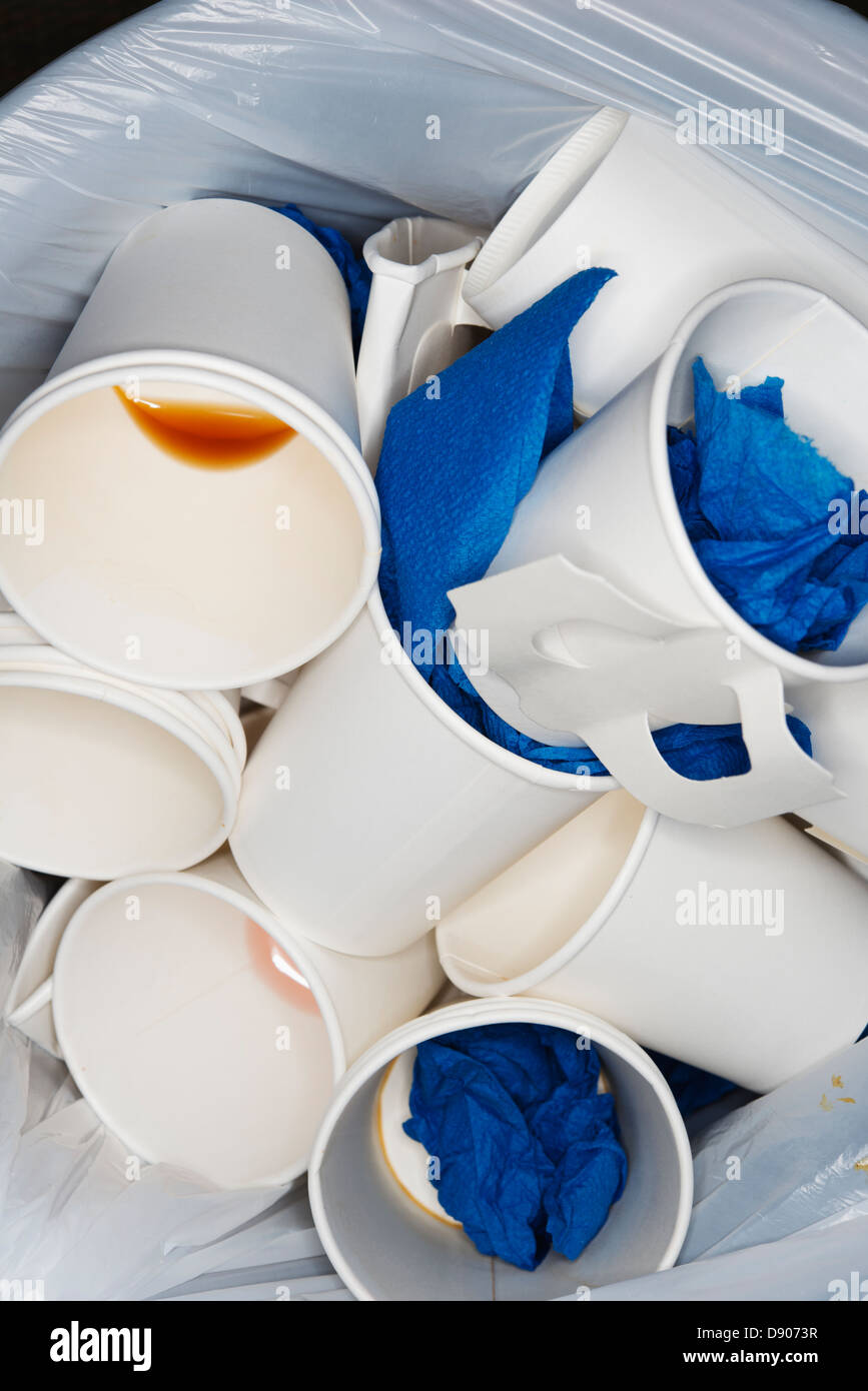 Disposable cups in bin, close-up Stock Photo - Alamy