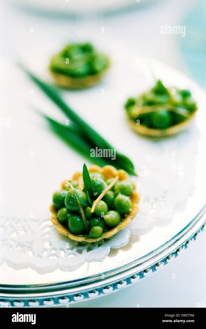 Small canapes with green peas Stock Photo - Alamy