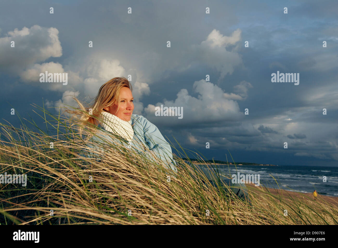 A woman at the beach in a storm Stock Photo - Alamy