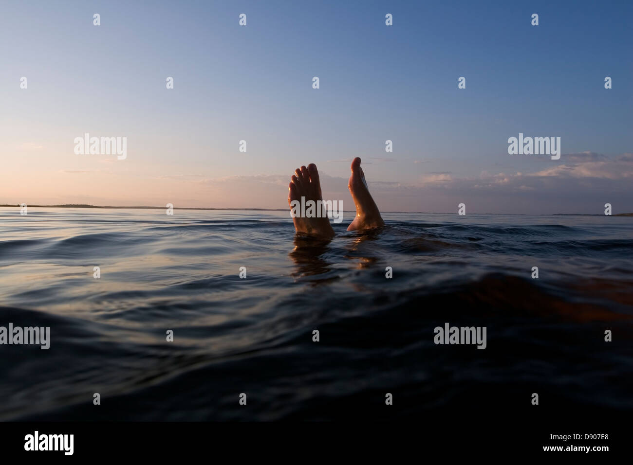Feet between waves in the sea Stock Photo - Alamy