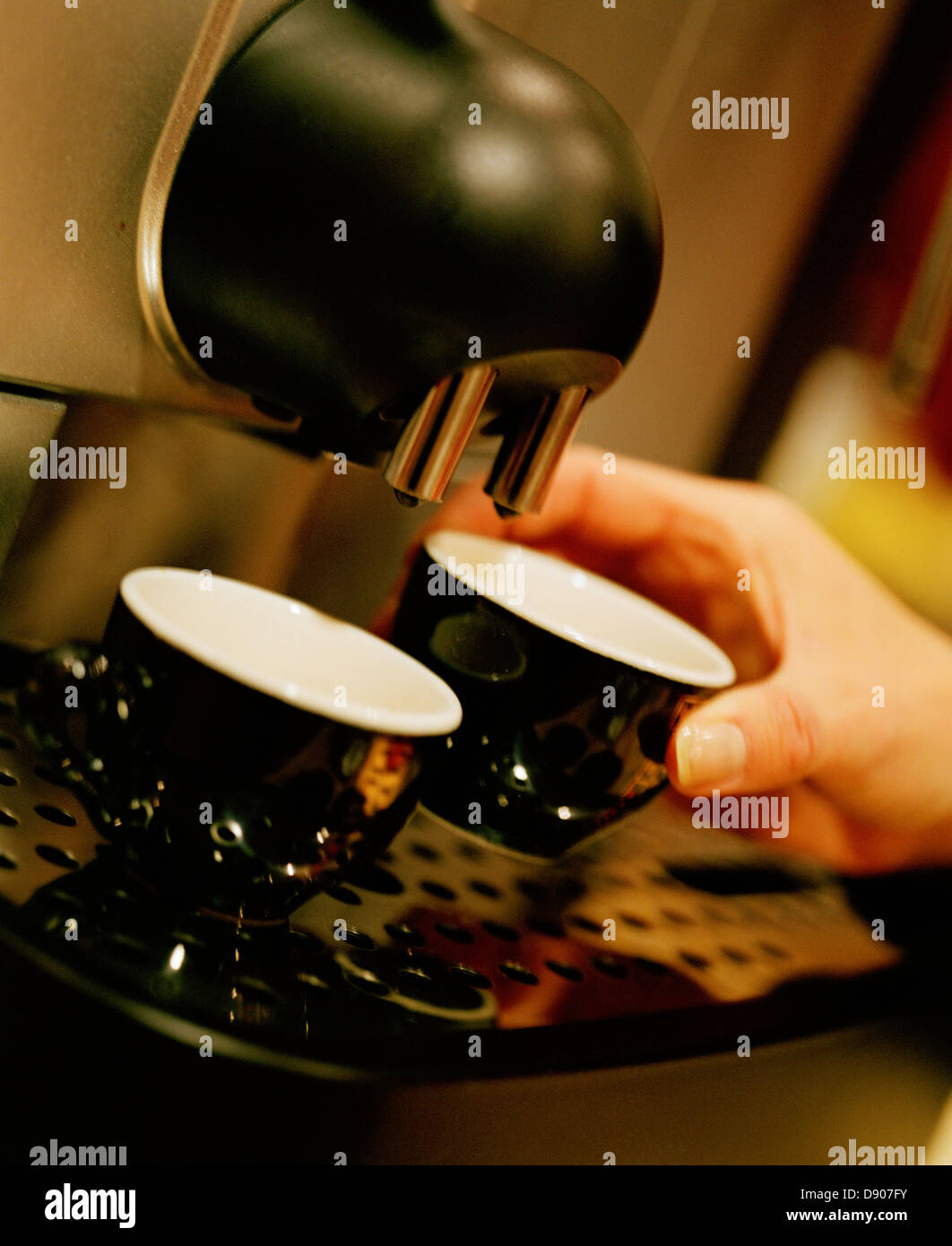 Cup at a coffee maker Stock Photo - Alamy
