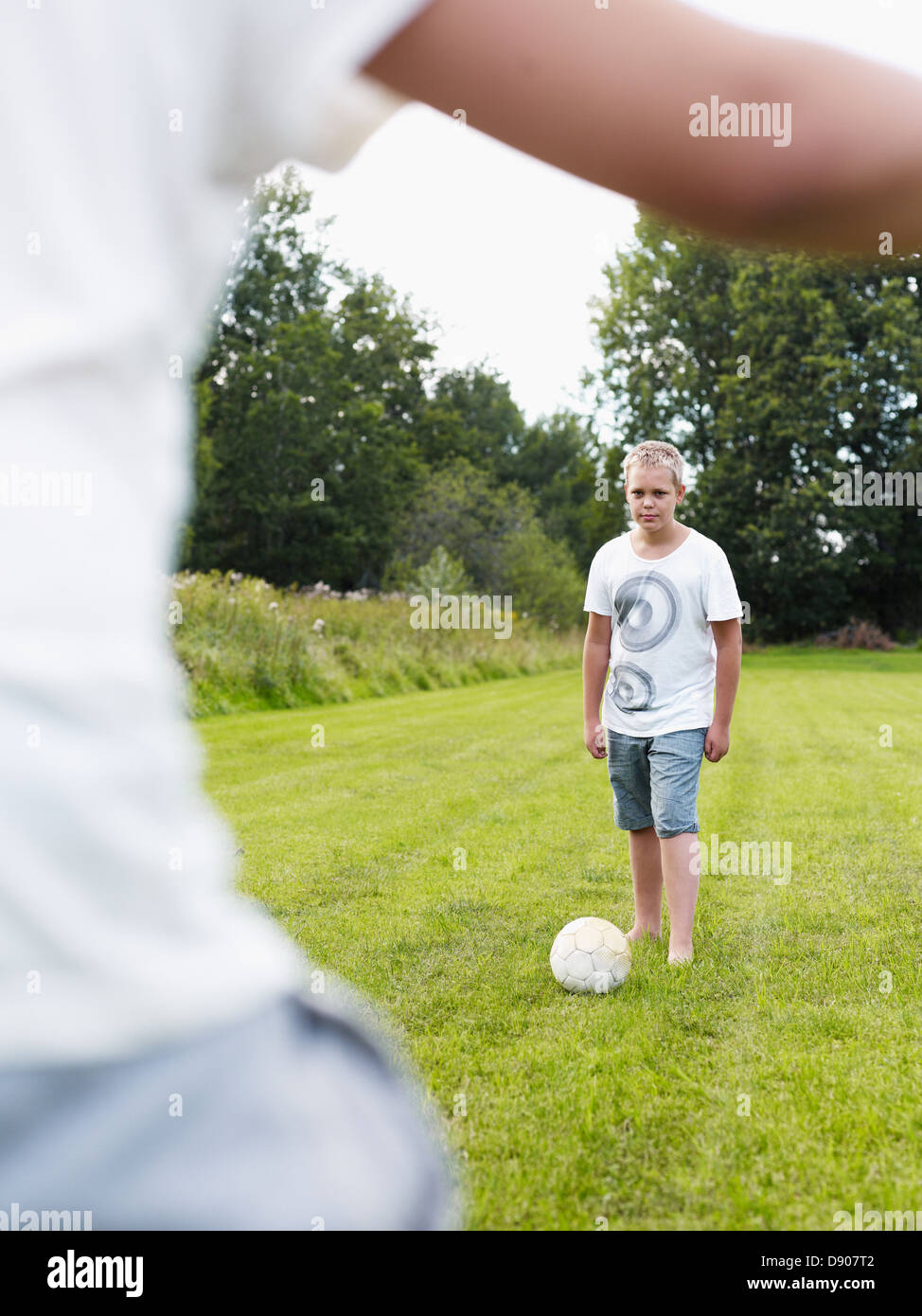 Two teenage boys playing soccer Stock Photo - Alamy