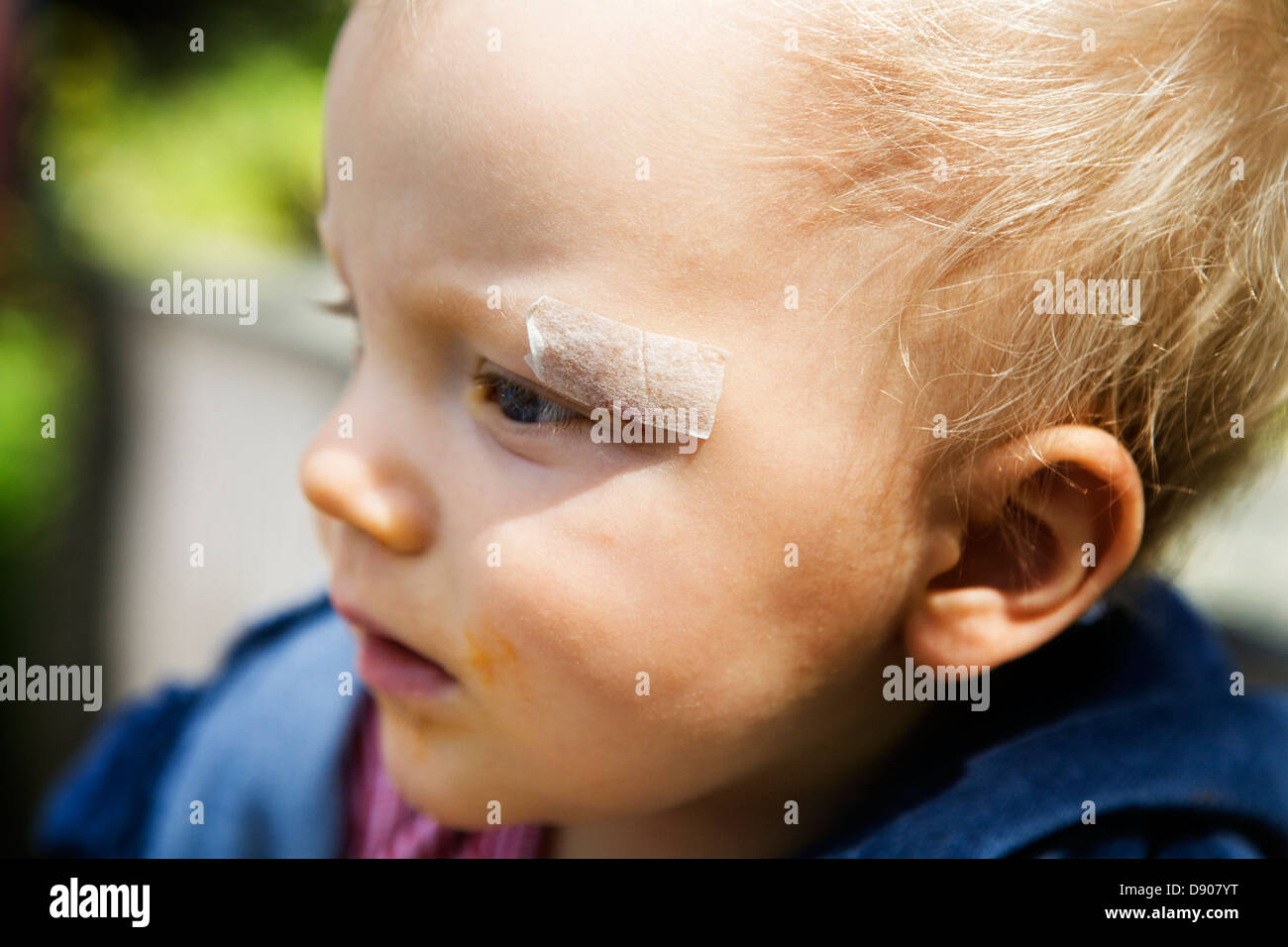 A little boy with plaster in the face Stock Photo - Alamy