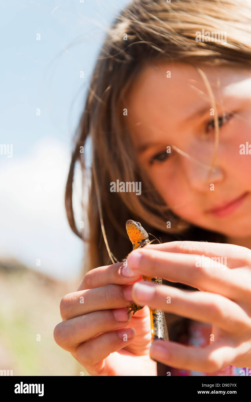Girl holding lizard Stock Photo - Alamy