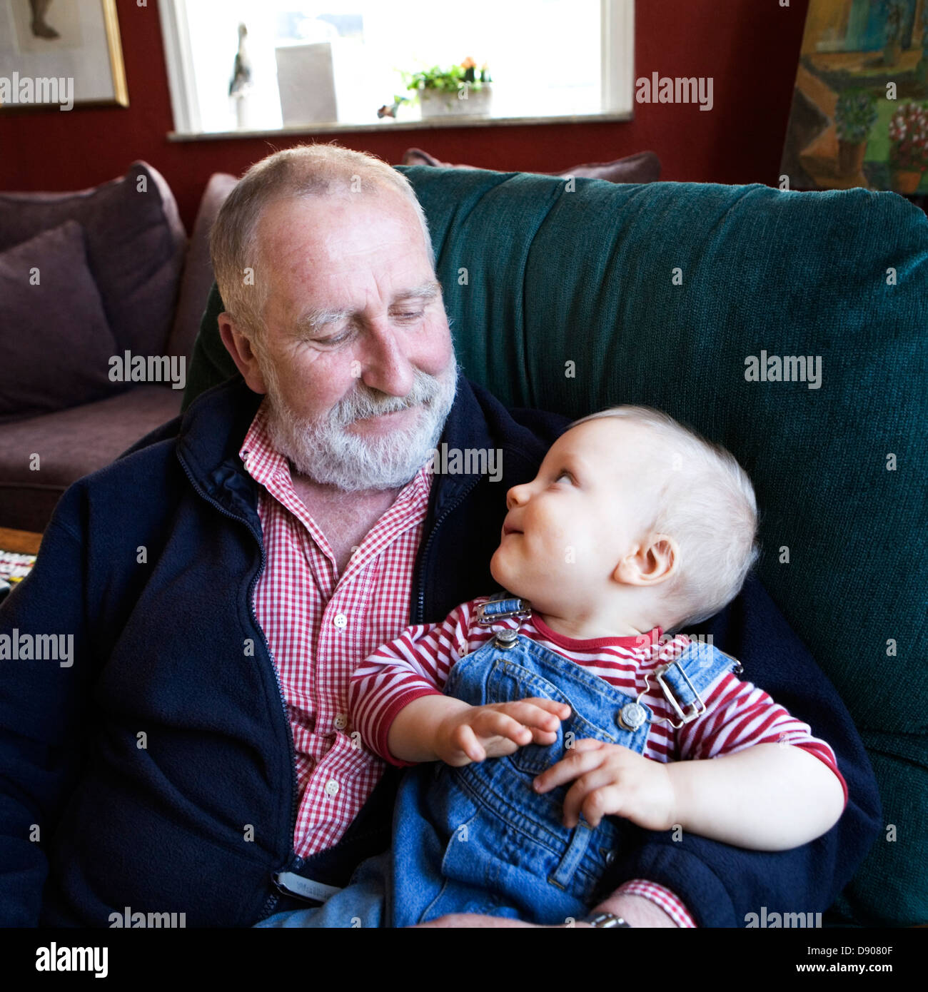 A man with a boy on his lap Stock Photo - Alamy