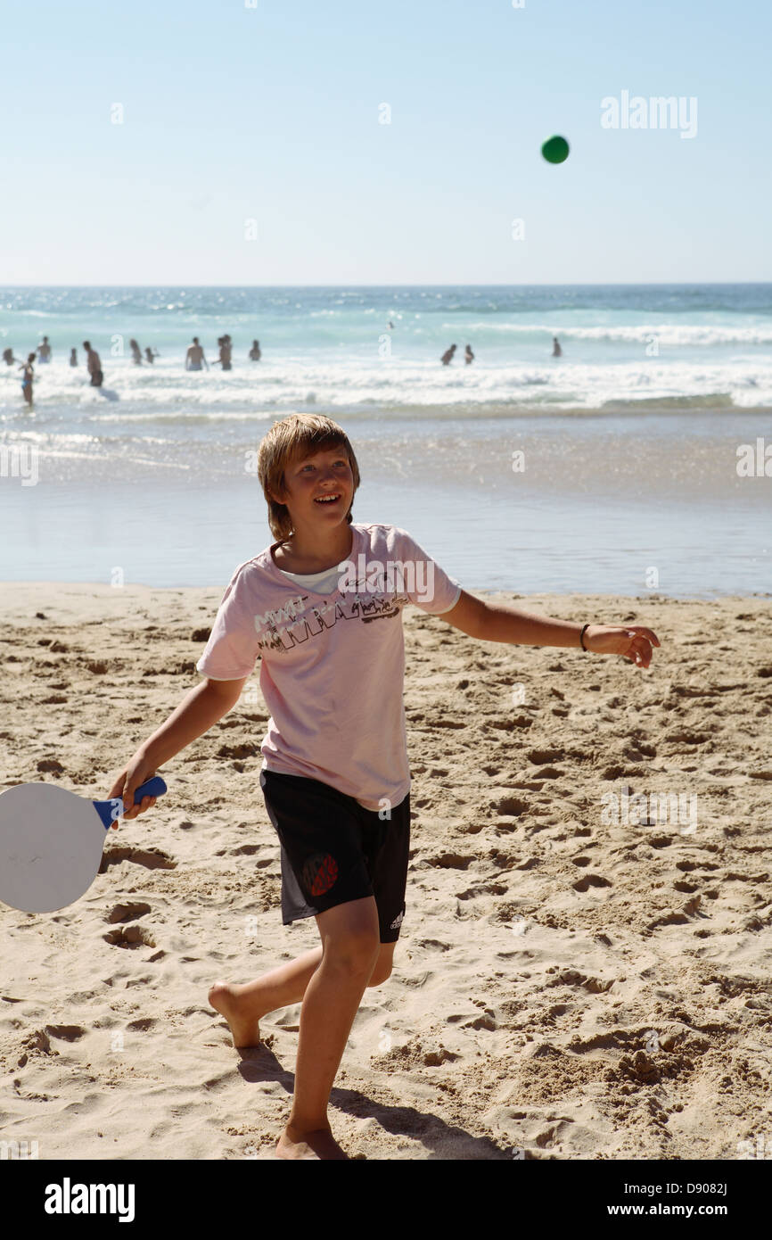 A boy playin beach tennis Stock Photo - Alamy