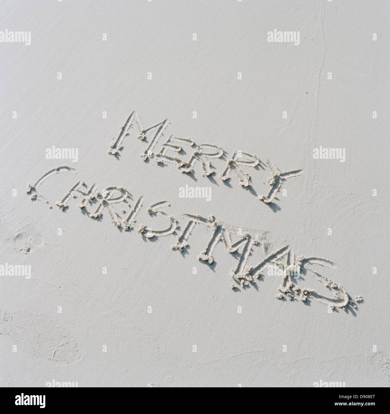 Merry Christmas written in sand Stock Photo - Alamy
