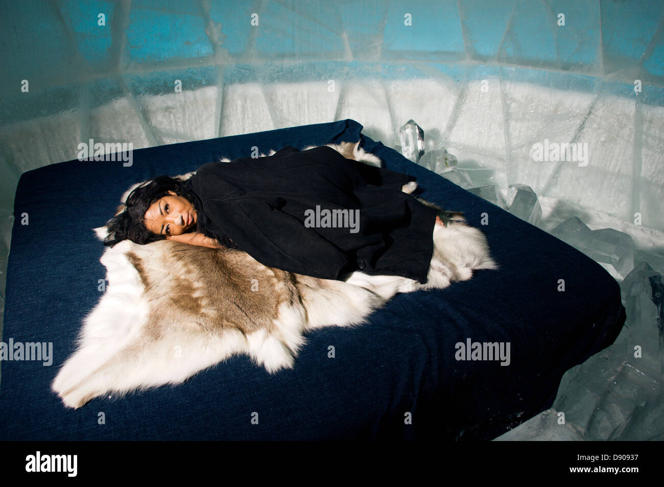 Woman lying on a bed in an ice hotel, Sweden Stock Photo - Alamy
