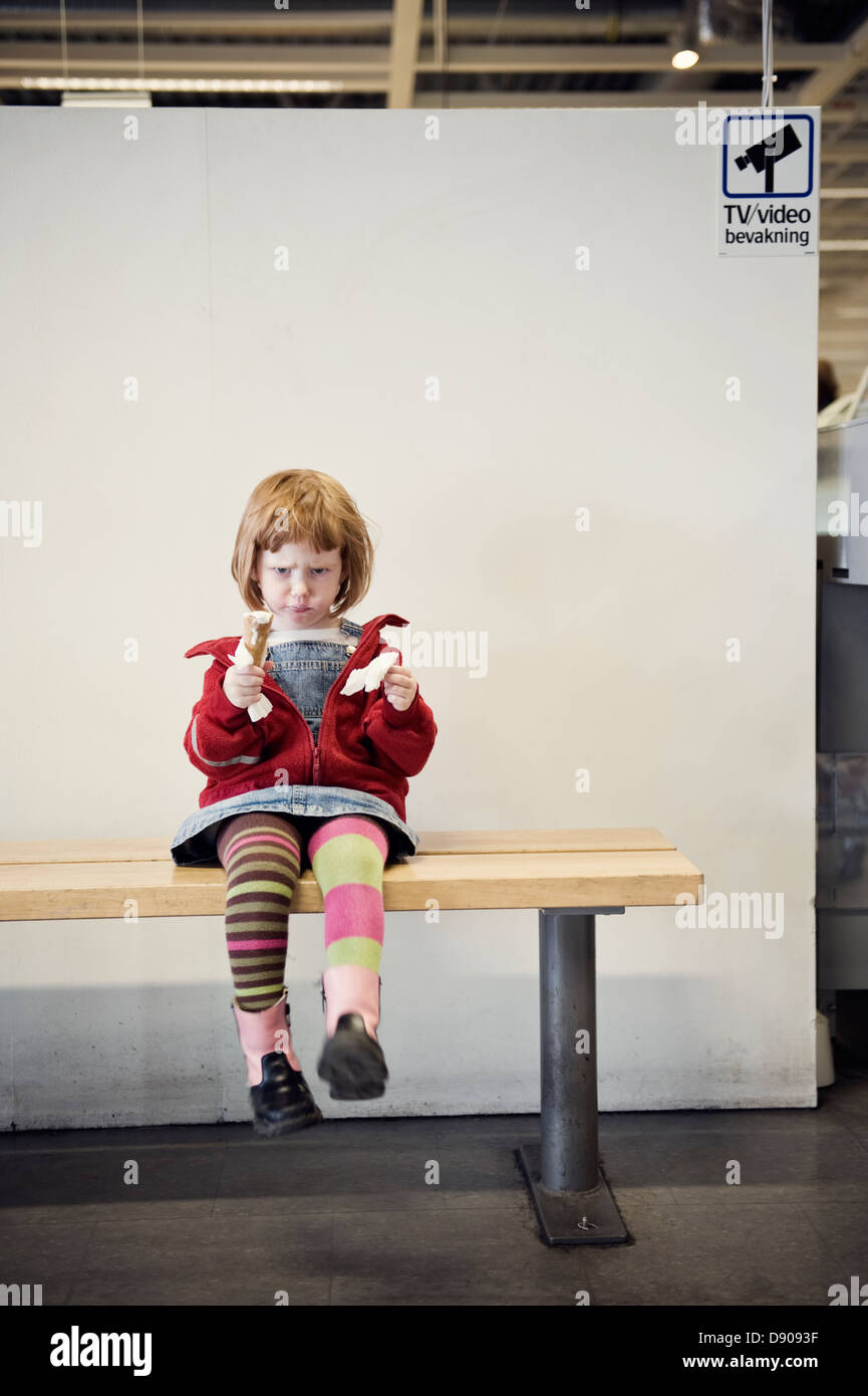 An angry little girl sitting on a bench, Sweden Stock Photo - Alamy