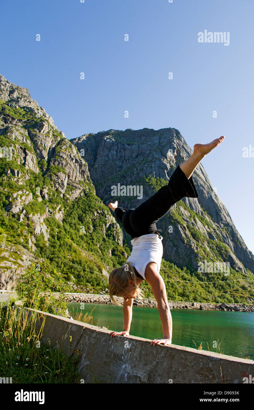 Woman doing a handstand, Norway Stock Photo - Alamy