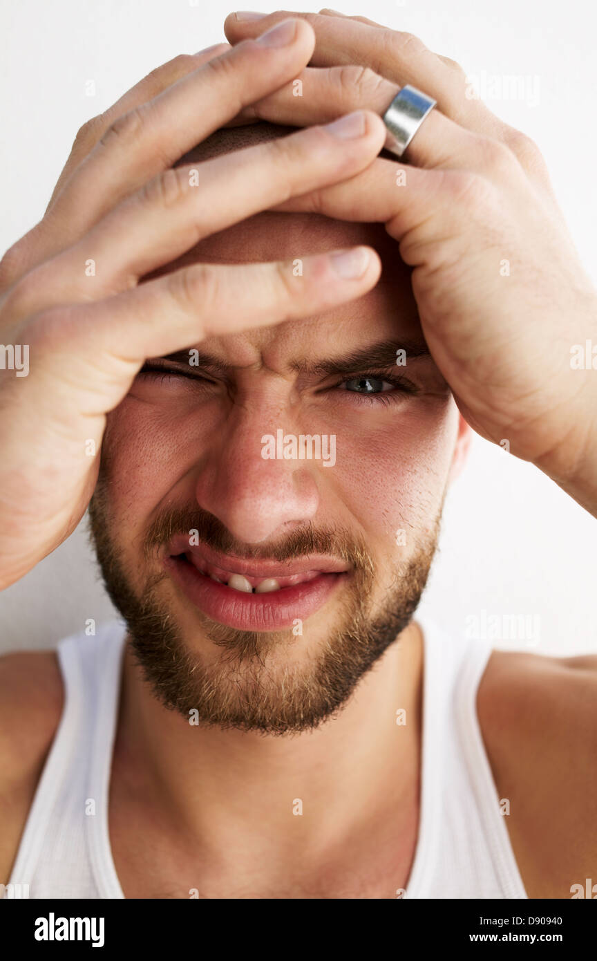 Man holding his hands on the forehead, South Africa Stock Photo - Alamy