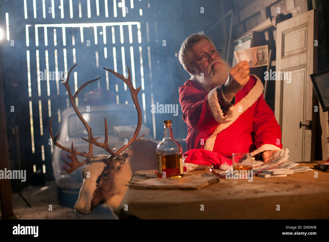 Santa Claus in a barn with a reindeer, Sweden Stock Photo - Alamy