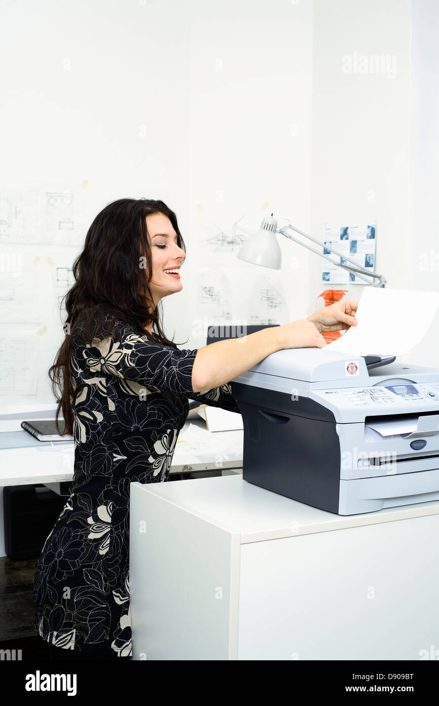 A smiling woman in an office Stock Photo - Alamy