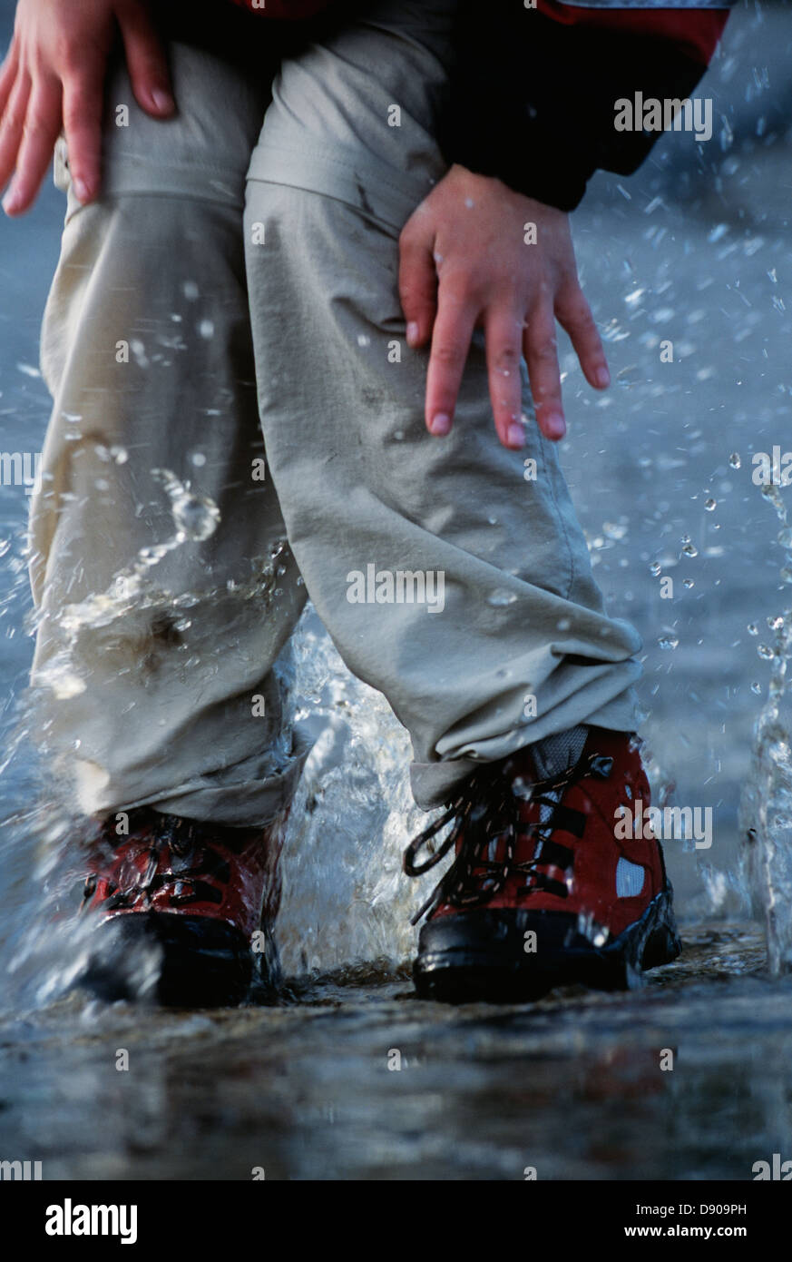 Girl splashing puddle hi-res stock photography and images - Alamy