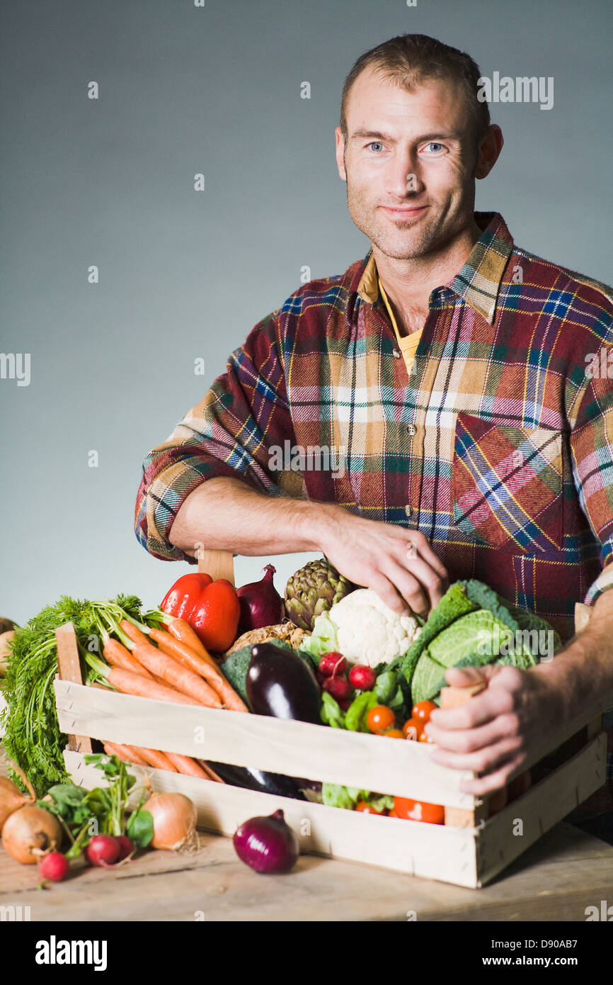 Man holding a box of vegetables Stock Photo - Alamy