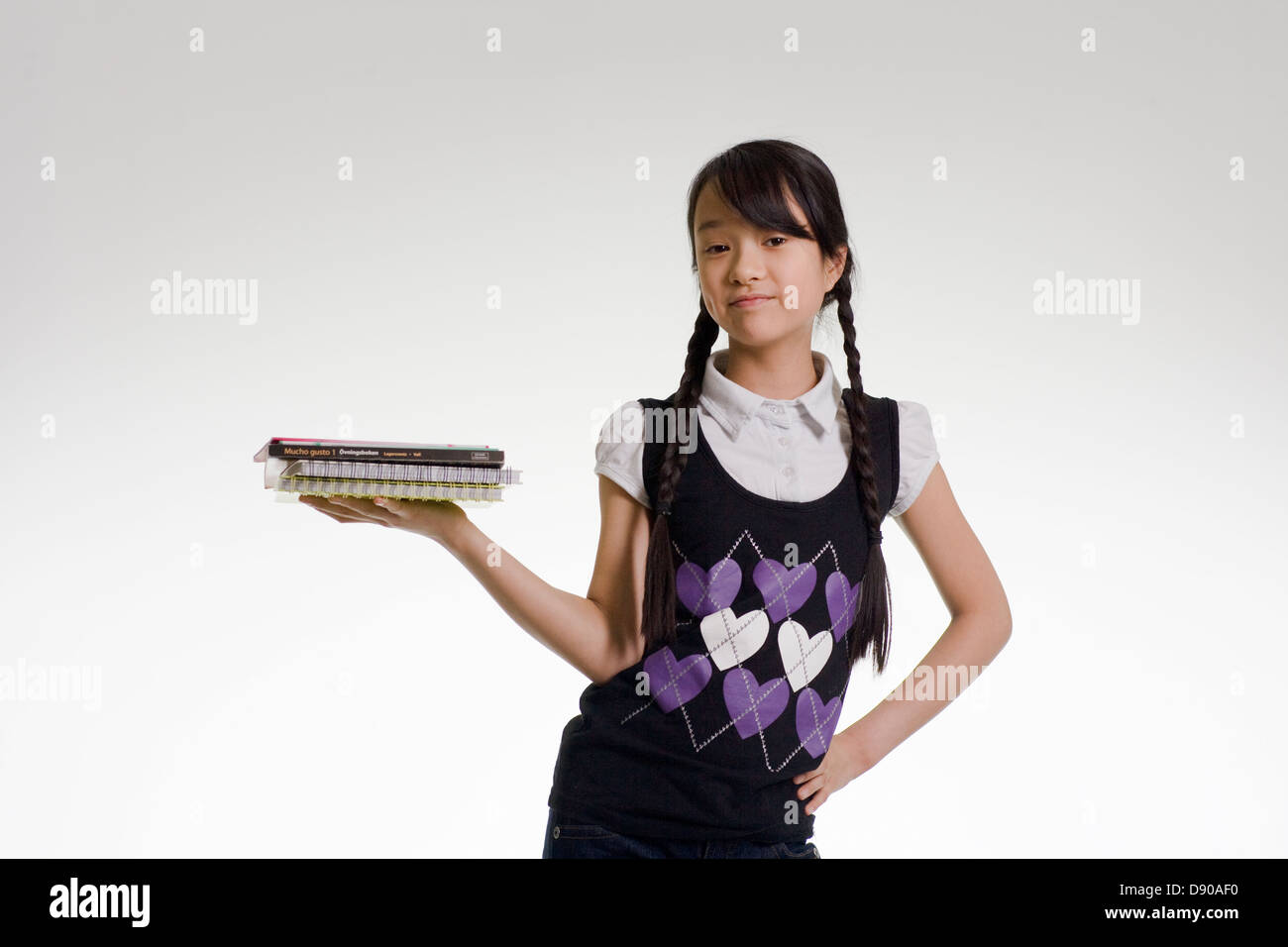 Schoolgirl holding books Stock Photo - Alamy