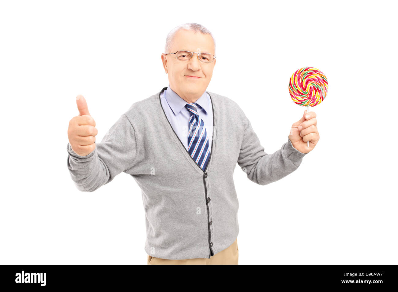 Smiling gentleman holding a colorful lollipop and giving thumb up ...