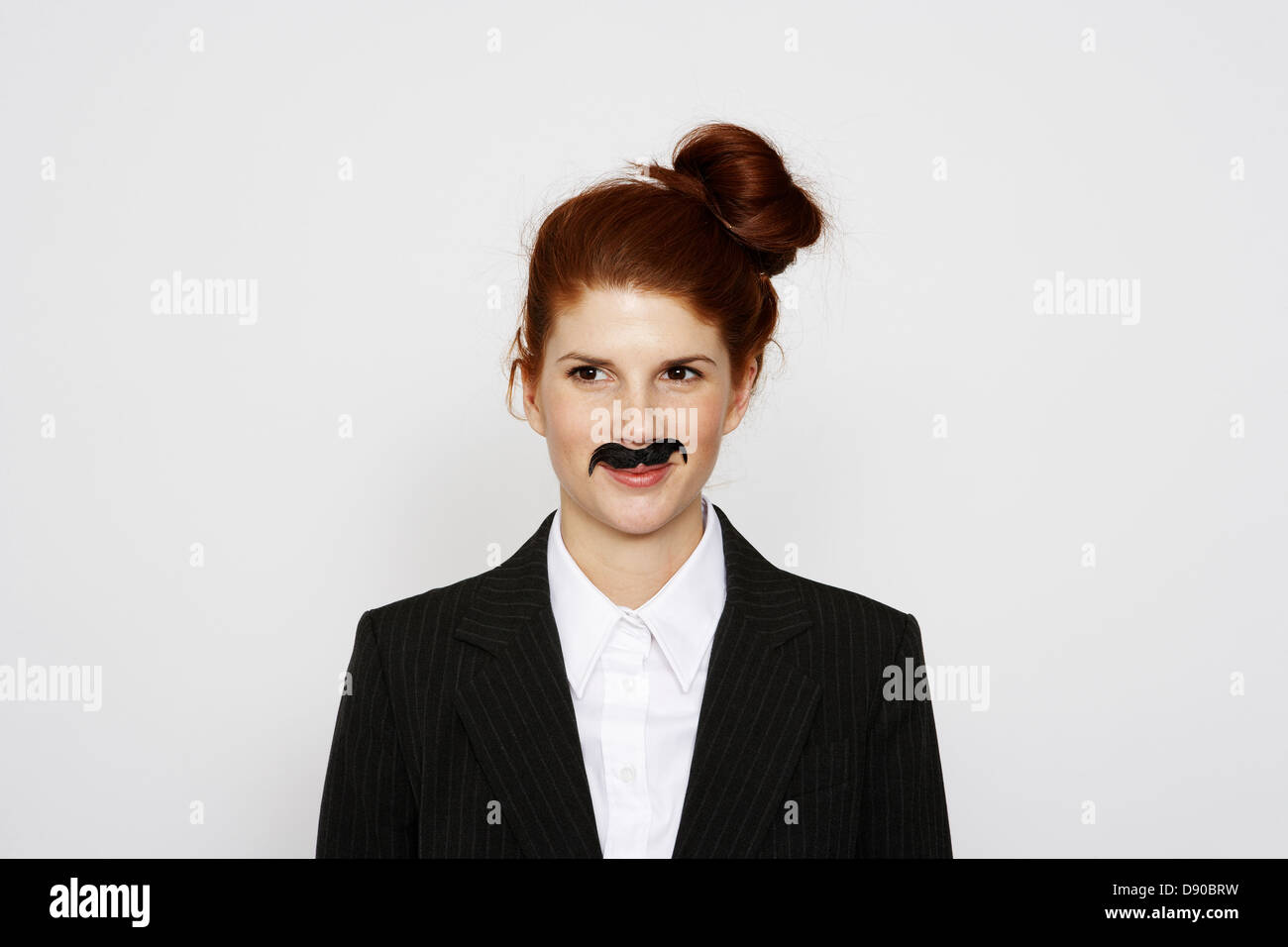 A woman in a suit wearing a fake moustache Stock Photo - Alamy