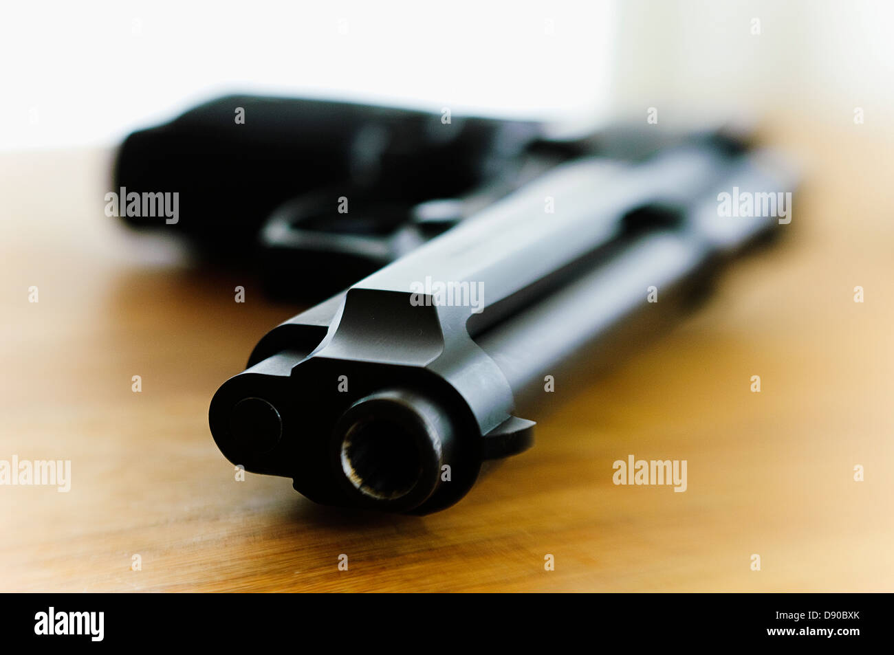A pistol on a table Stock Photo - Alamy
