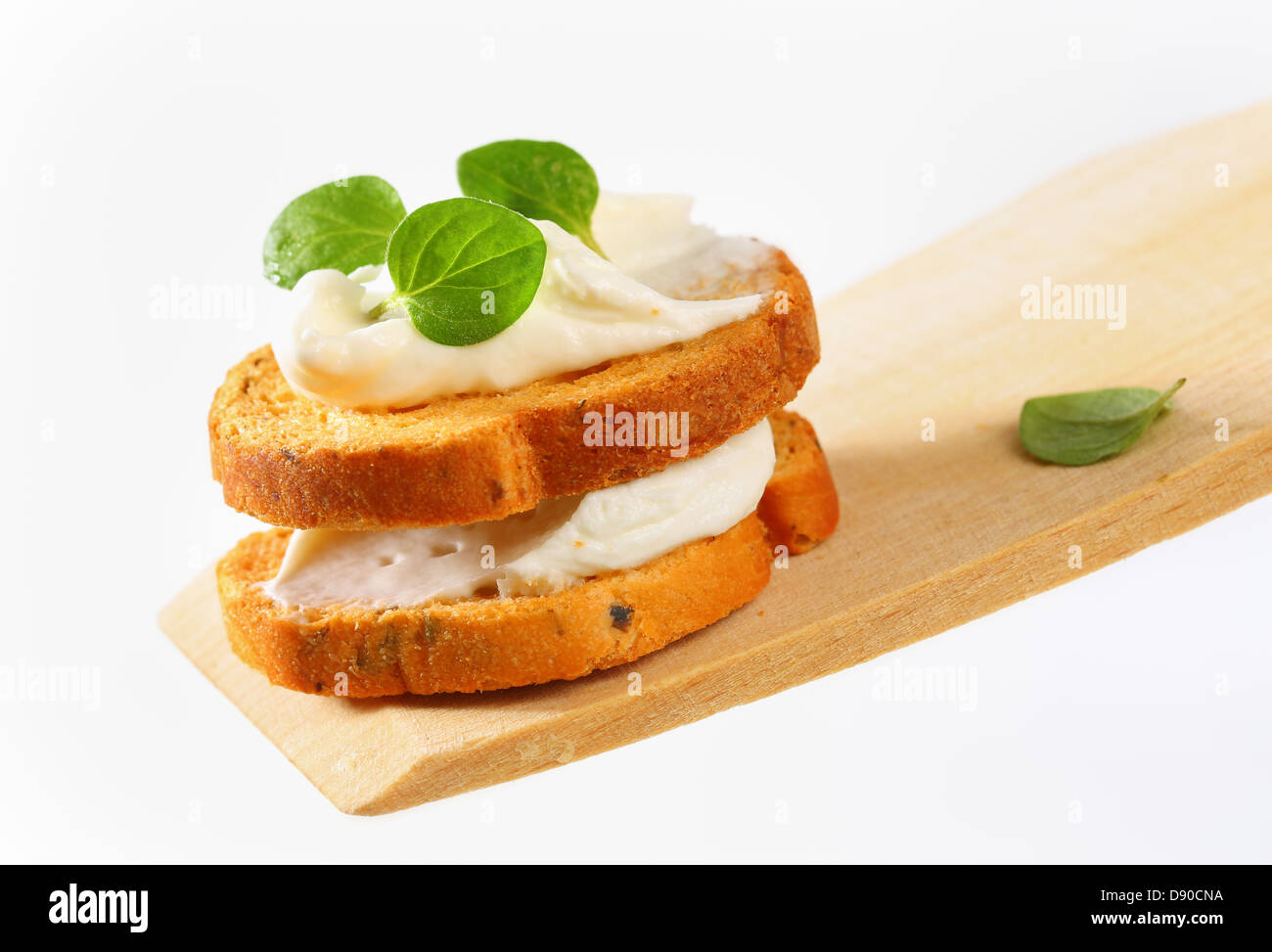 Small round toasts with cheese spread Stock Photo - Alamy