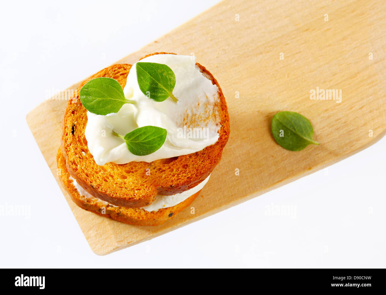 Small round toasts with cheese spread Stock Photo - Alamy