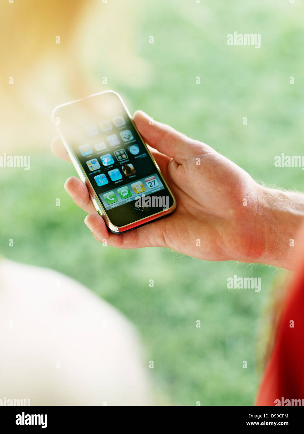 A hand holding an Iphone Stock Photo - Alamy