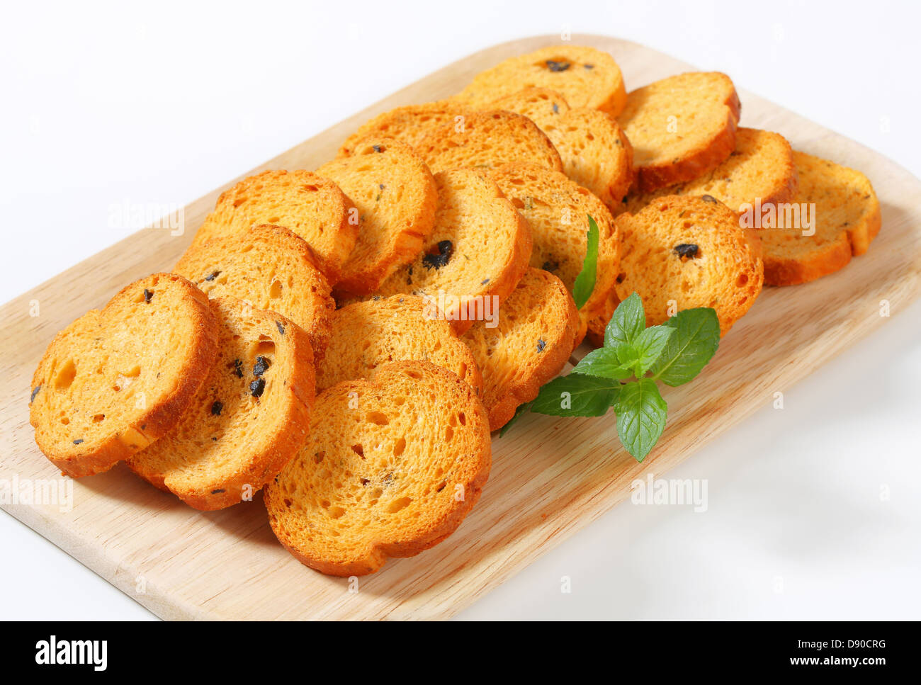 Small round toasts with black olives Stock Photo - Alamy