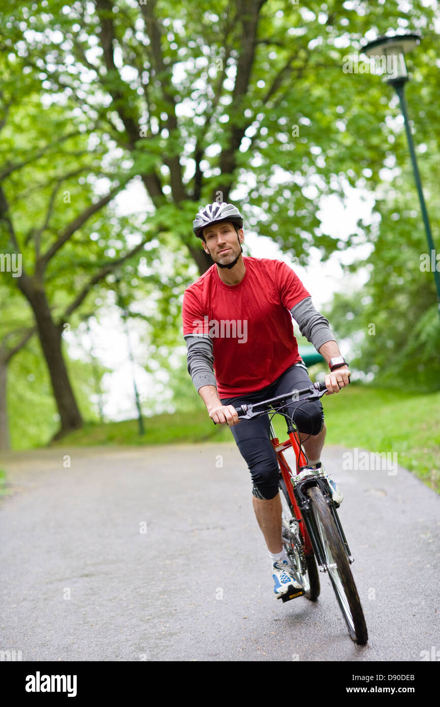 Man riding mountain bike in park Stock Photo - Alamy