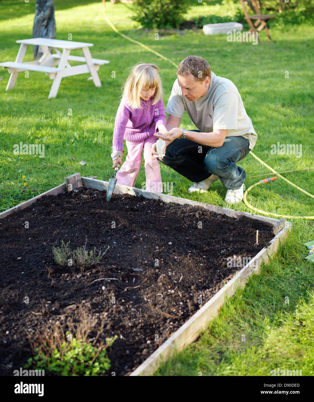 Child parent planting seeds hi-res stock photography and images - Alamy