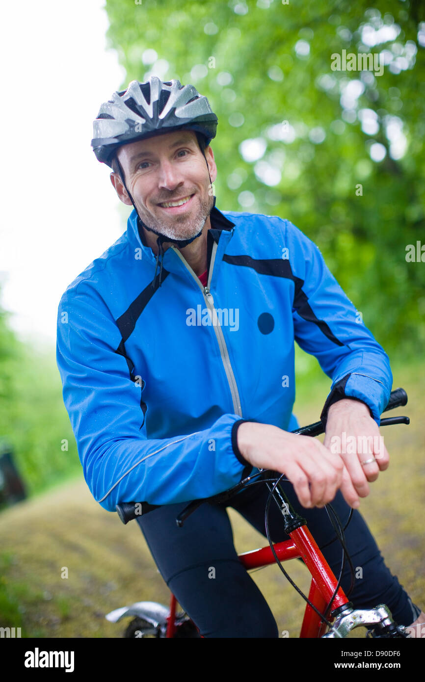 Portrait of man riding mountain bike in park Stock Photo - Alamy