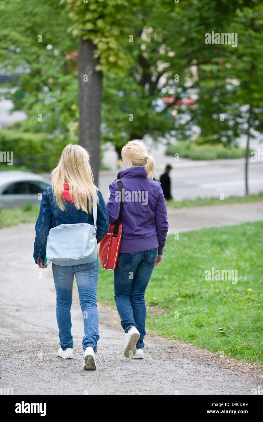 Two girls park rear view hi-res stock photography and images - Alamy