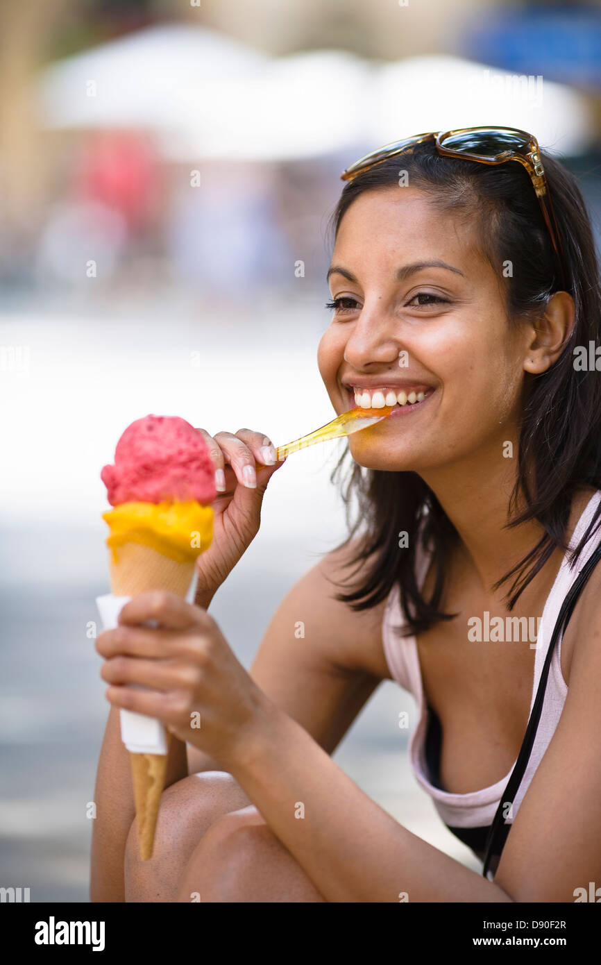 Woman eating ice cream outdoors Stock Photo - Alamy