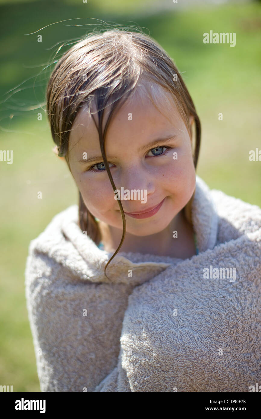 Girl wrapped in towel, smiling Stock Photo - Alamy