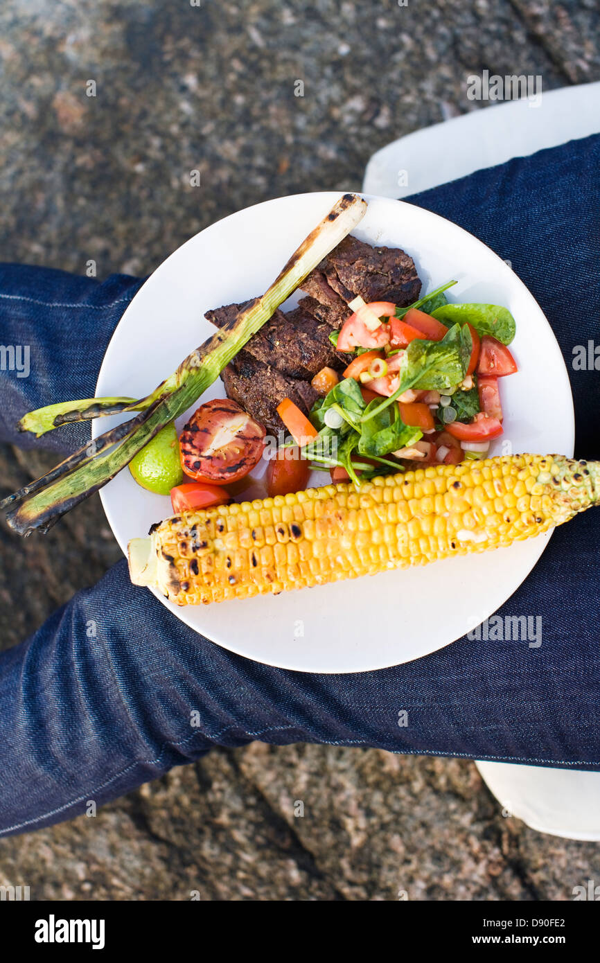 Plate with salad and corn cob Stock Photo - Alamy