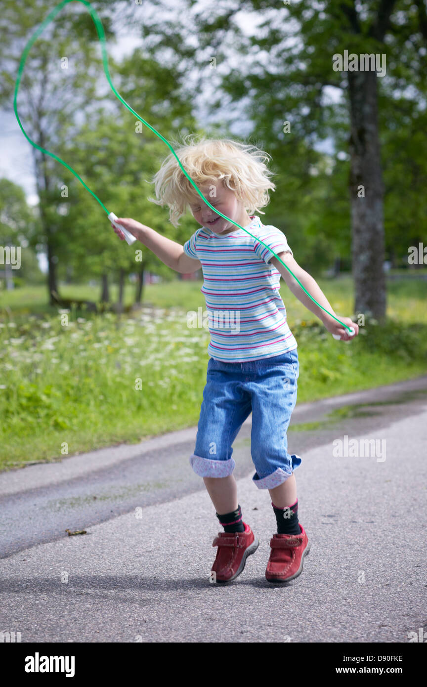 Girl playing with skipping rope hi-res stock photography and images - Alamy