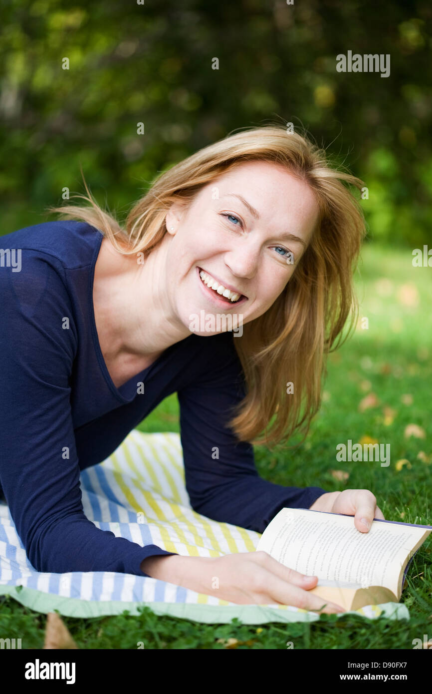 Woman reading looking at camera happy hi-res stock photography and ...