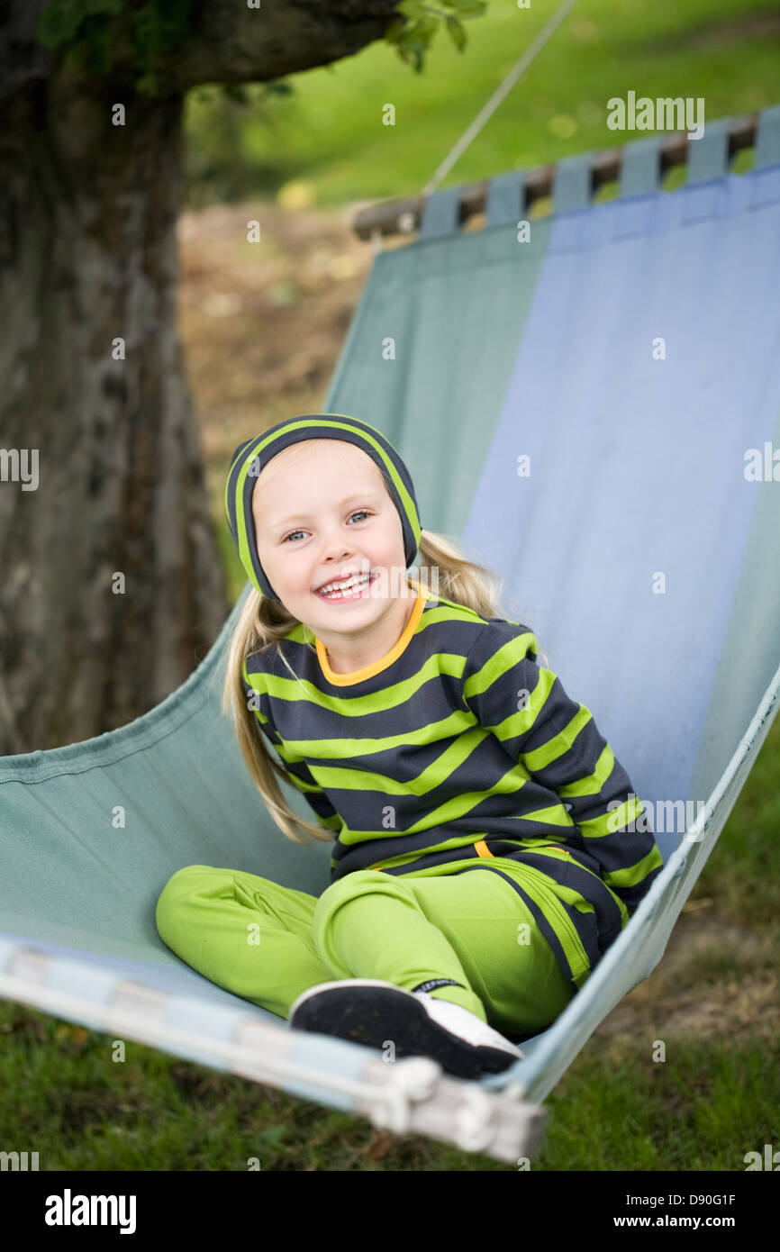 Girl sitting in hammock Stock Photo - Alamy