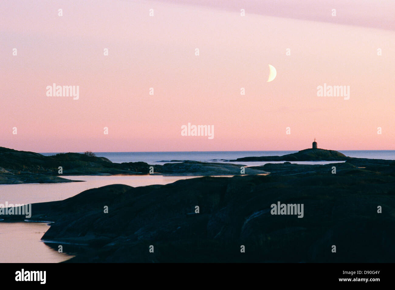 A moon on pink sky in the archipelgo of Stockholm, Sweden Stock Photo ...