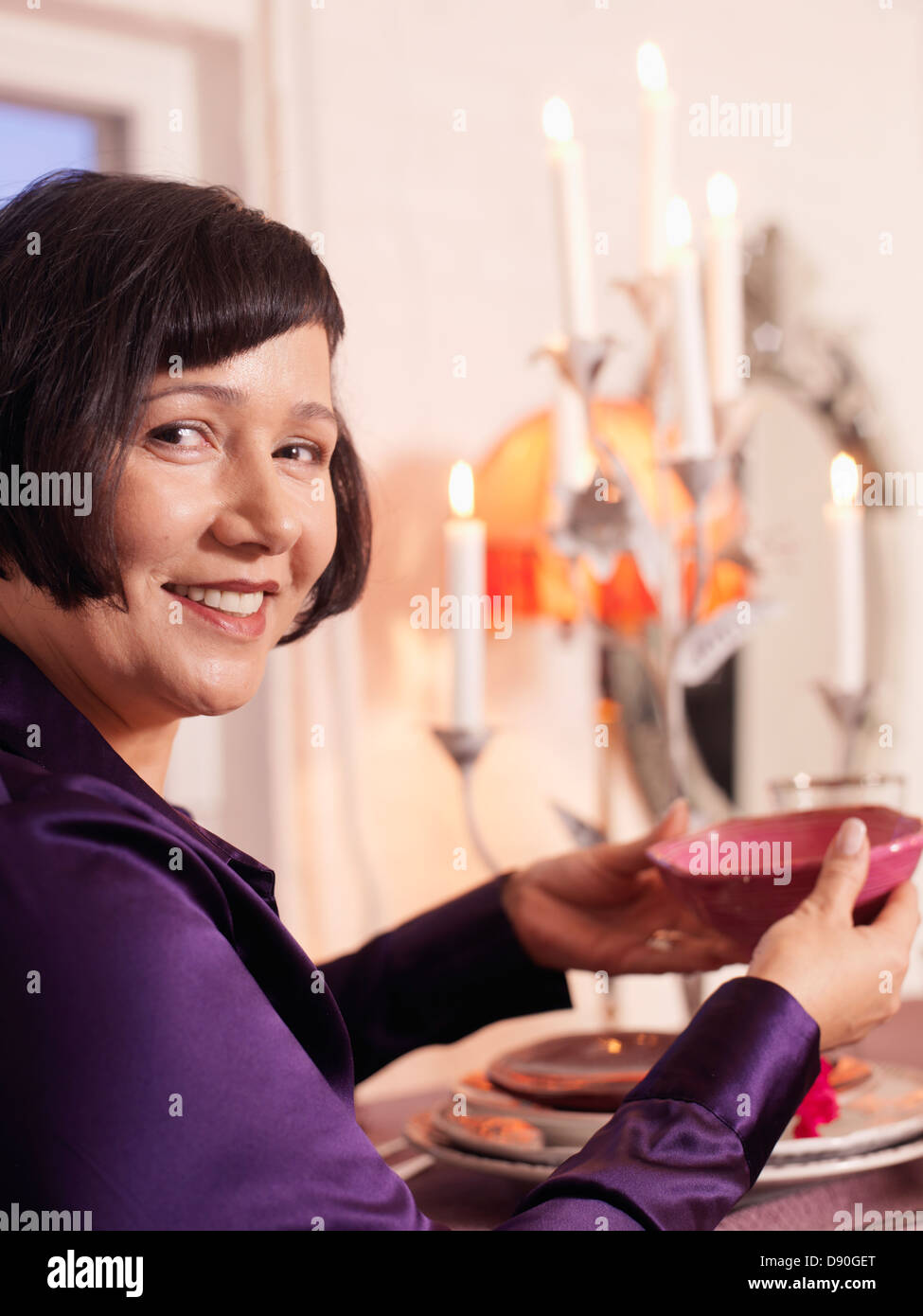 Woman holding bowl, looking at camera Stock Photo - Alamy