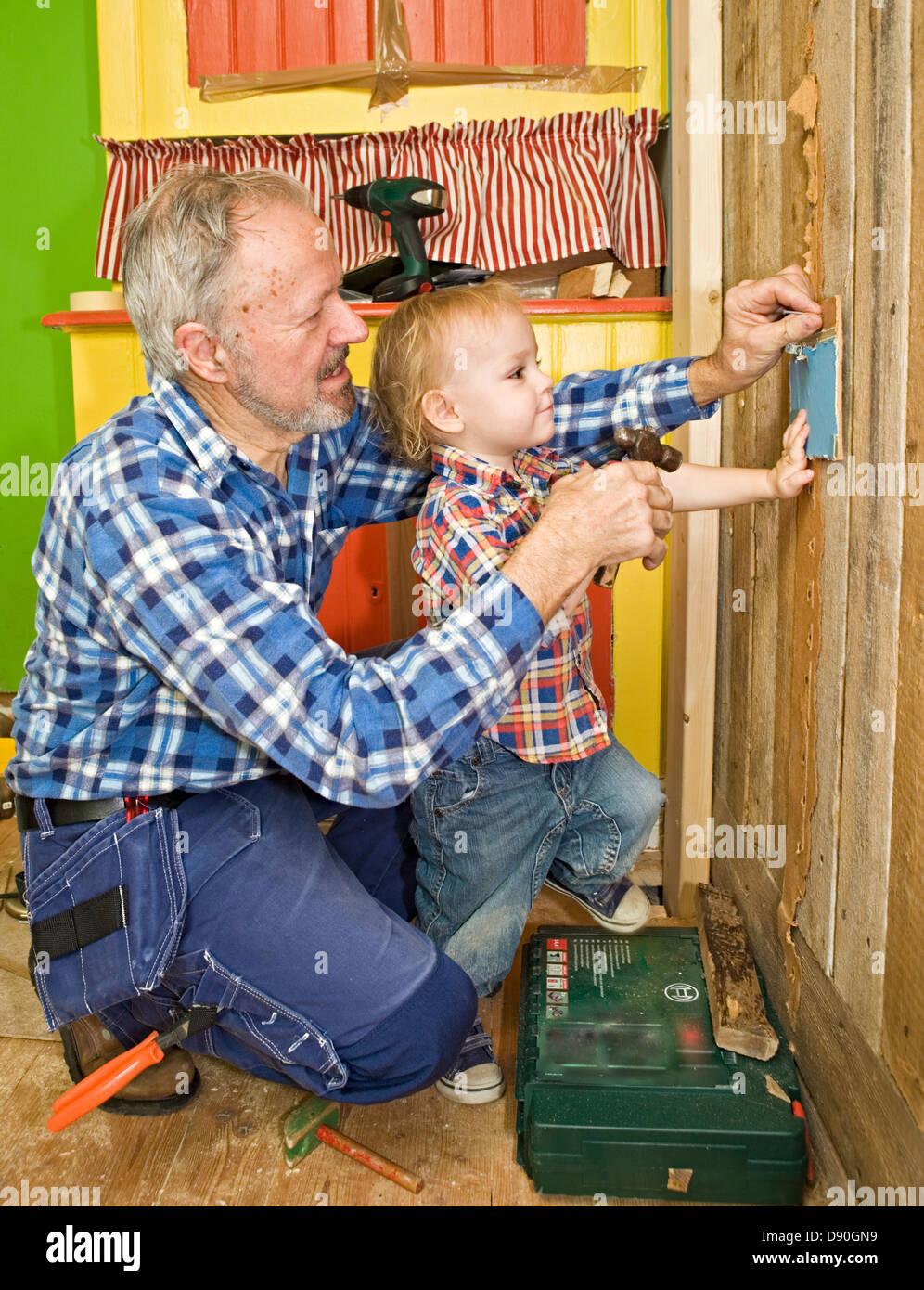 A senior man doing carpentry with his grandchild, Sweden Stock Photo ...