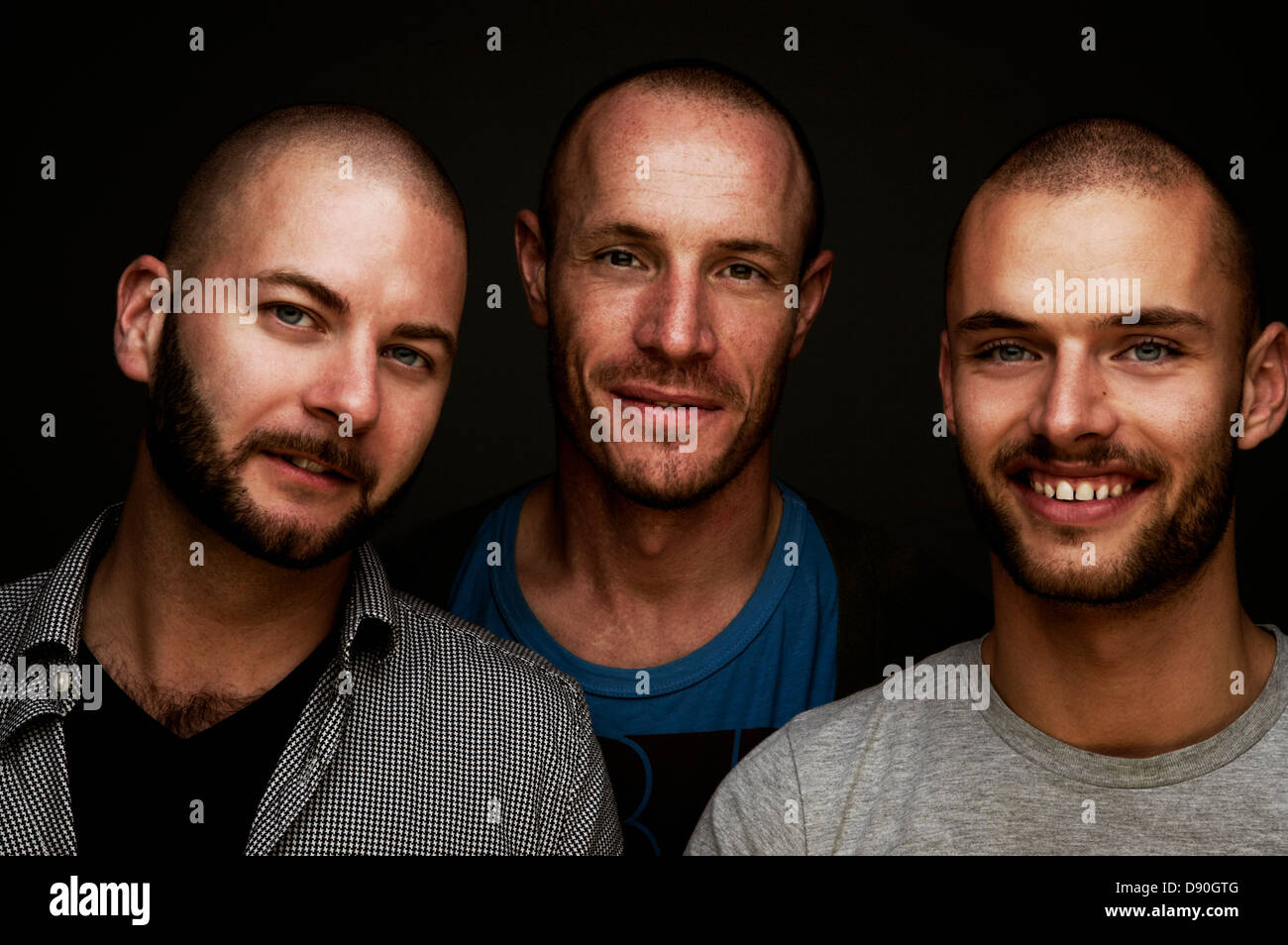 Three men standing, smiling, portrait Stock Photo - Alamy