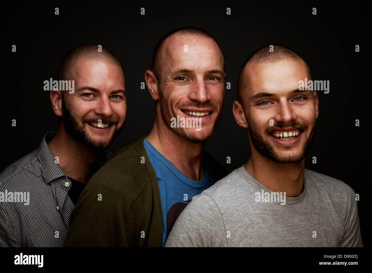 Three men standing, smiling, portrait Stock Photo - Alamy
