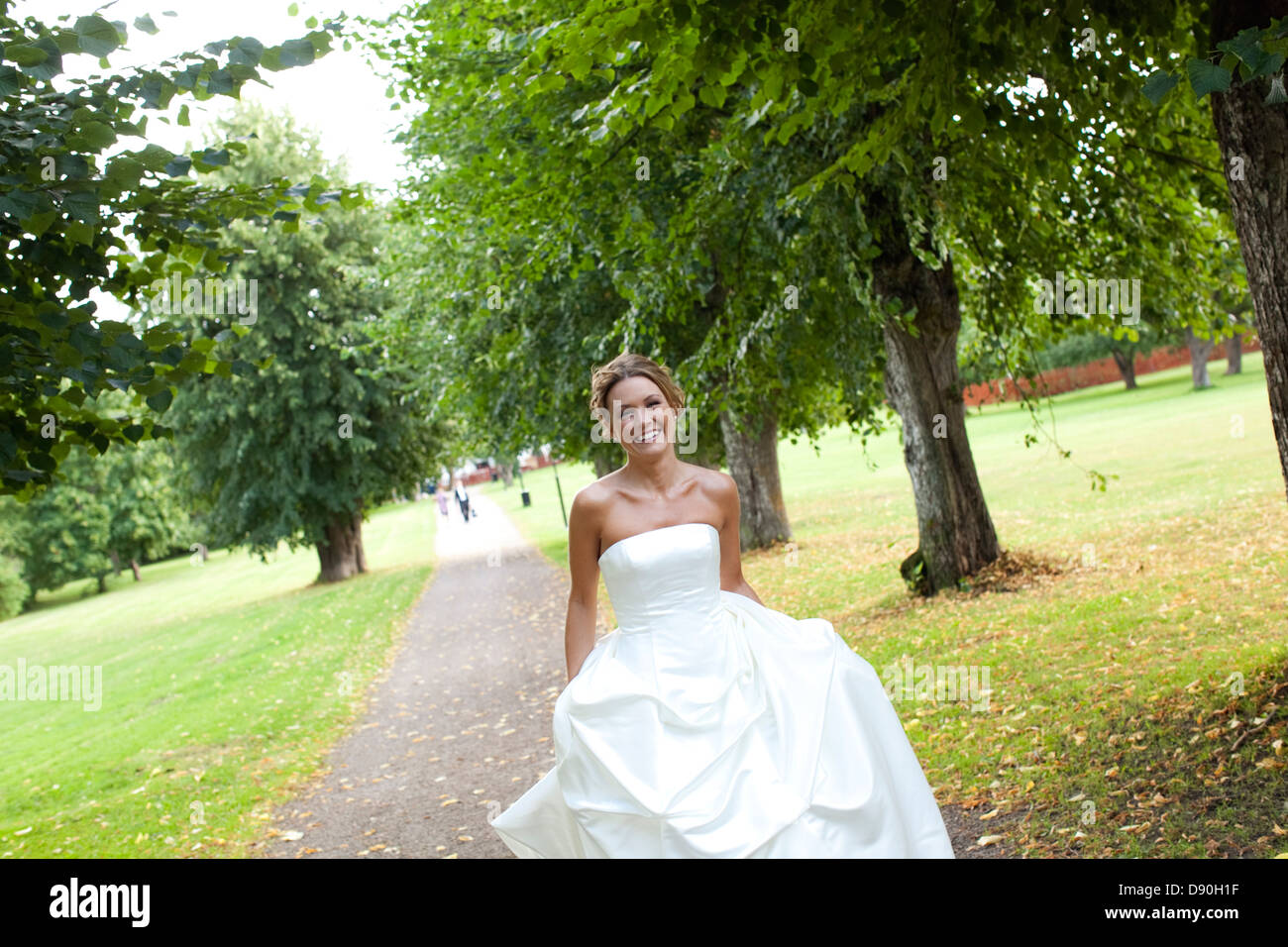 Bride running in park Stock Photo - Alamy