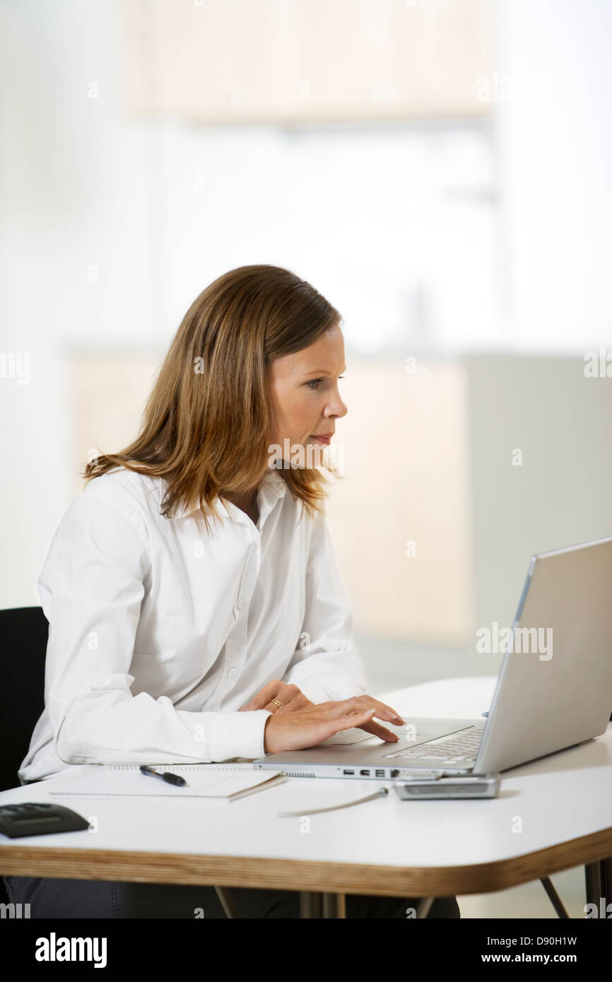 A woman working in an office Stock Photo - Alamy