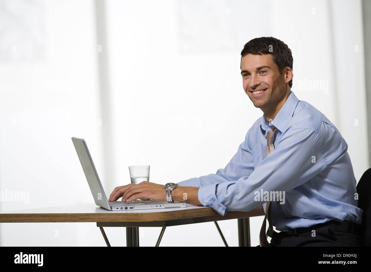 A man with a computer in an office Stock Photo - Alamy