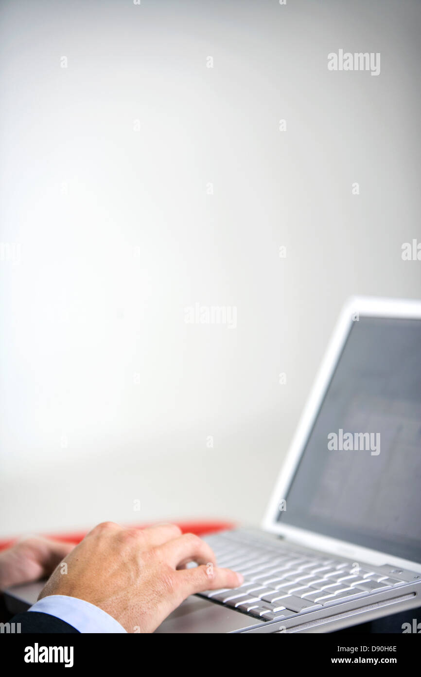A man with a computer in an office Stock Photo - Alamy
