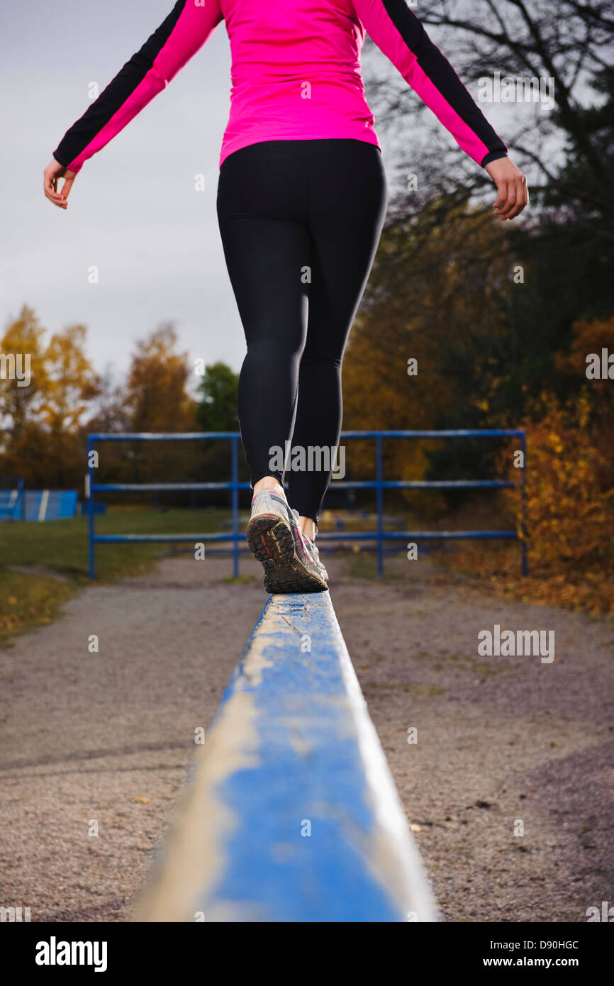 Woman walking on hurdles Stock Photo - Alamy