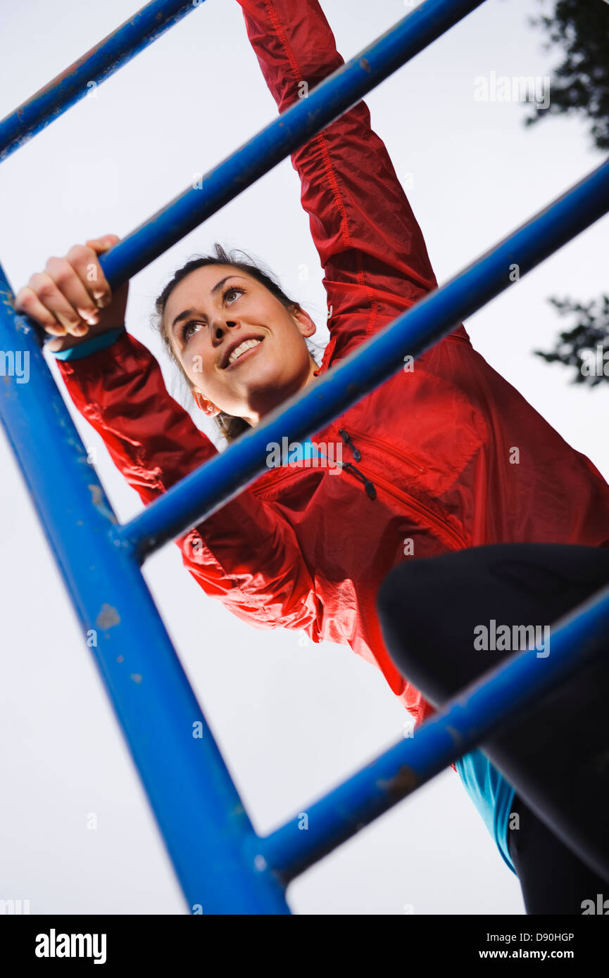 Woman climbing on ladder Stock Photo - Alamy
